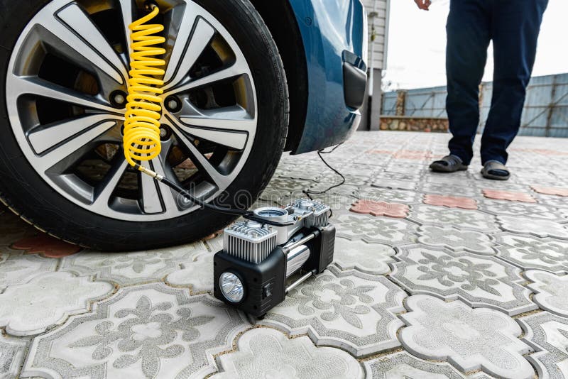 Automobile Compressor with Manometer Inflating Car Wheel. Stock Photo ...