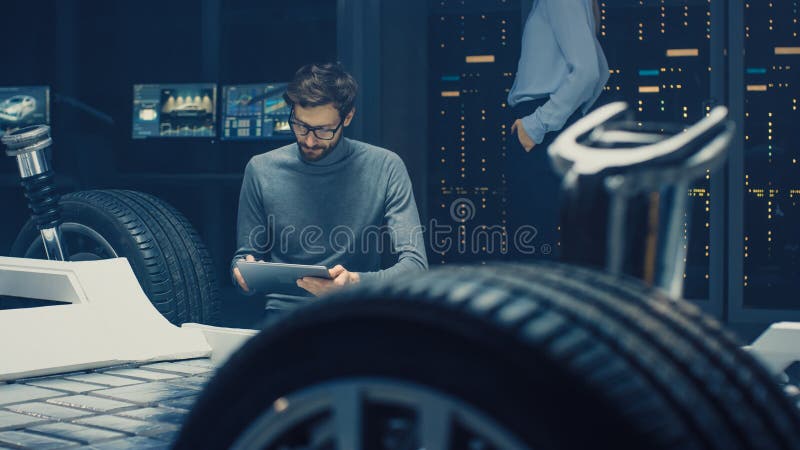 Automobile Design Engineer Sitting beside Hybrid Electric Car Chassis ...