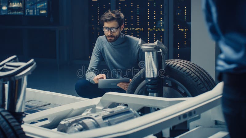 Automobile Design Engineer Sitting beside Hybrid Electric Car Chassis ...