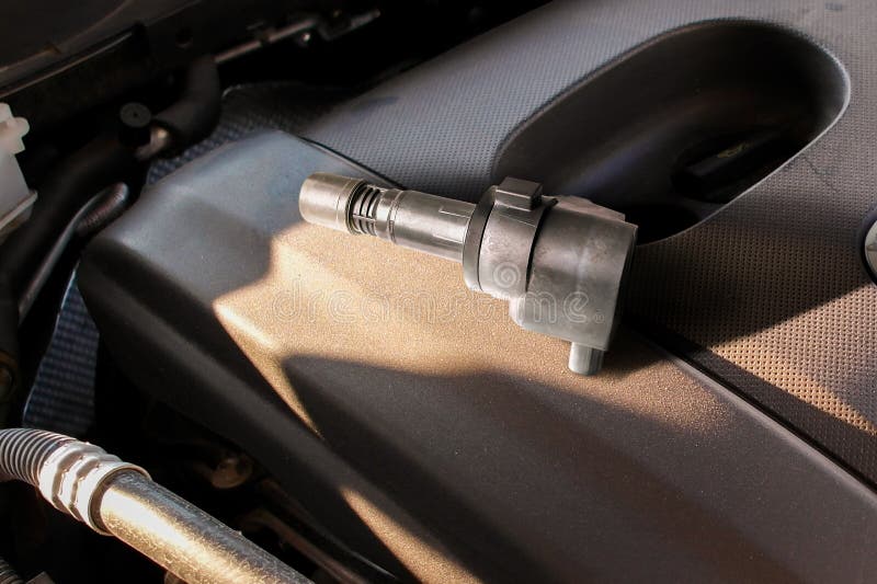 An Automobile Electronic Ignition Coil Located on the Engine Cover for ...