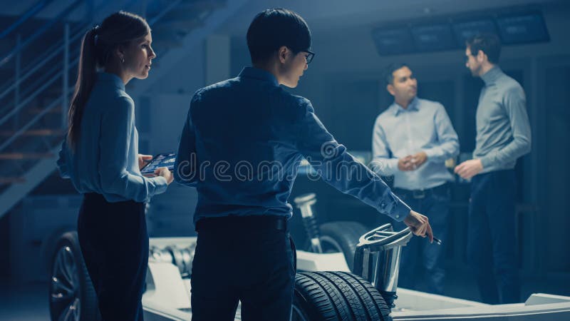 Automobile Engineers Discussing and Designing Electric Car Chassis ...