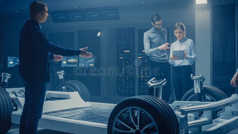 Automobile Engineers Discussing and Designing Electric Car Chassis ...
