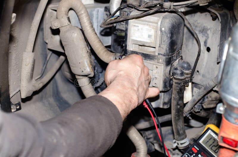 An Automobile Expert Uses a Measuring Device for Automatic Diagnostics ...