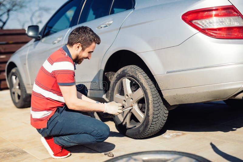 Man Chaning Tires Stock Photos - Free & Royalty-Free Stock Photos from ...