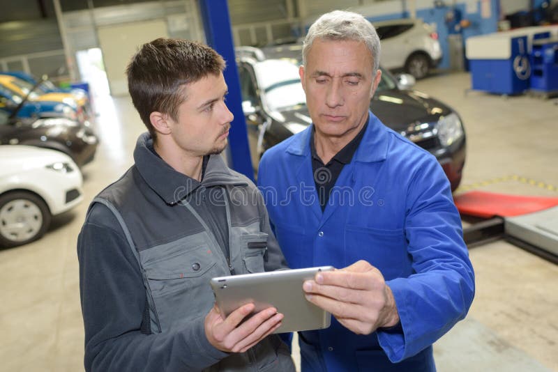 Automotive Apprentice Studying Automotive Trade Stock Image - Image of ...