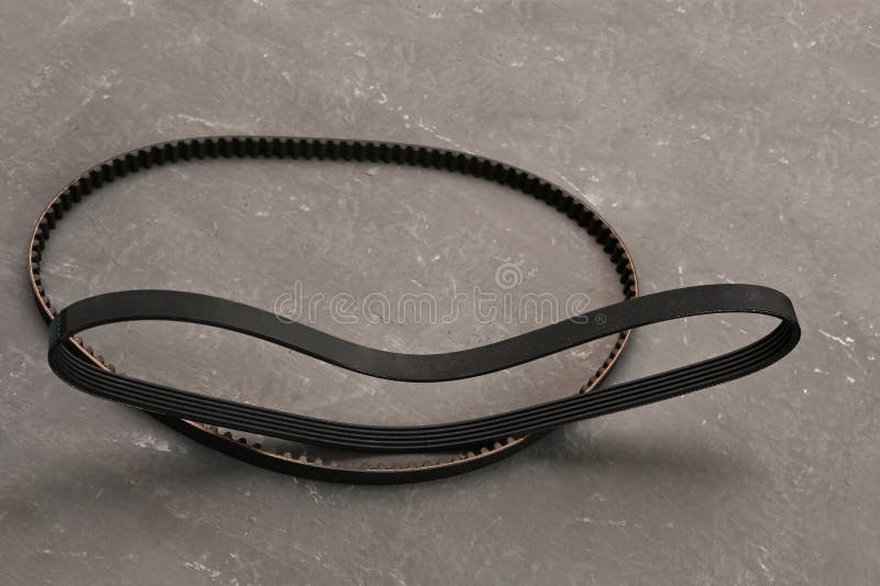 Automotive Belts Placed on Concrete Surface, Showcasing Essential Car ...