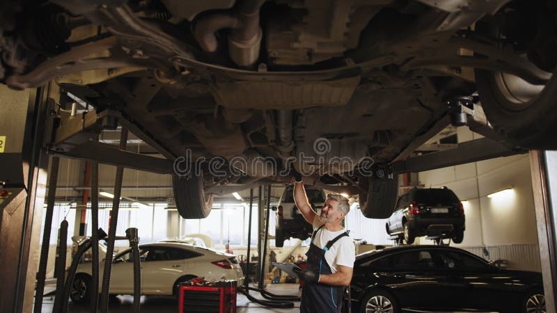 Automotive Breakdown. Experts at Work Shop, Standing in Safety Uniform ...