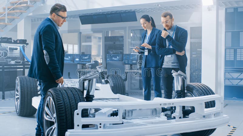 Automotive Design Engineers Talking while Working on Electric Car ...
