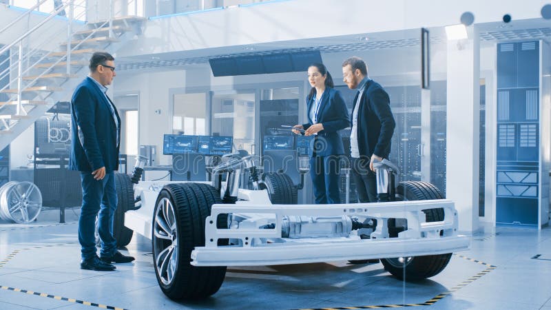 Automotive Design Engineers Talking while Working on Electric Car ...