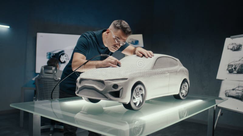 Automotive Engineer Makes the Design Corrections To a Prototype Model ...
