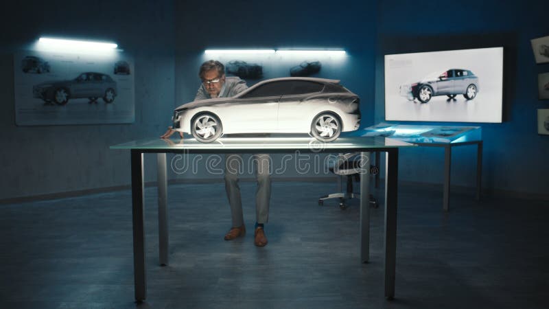 Automotive Engineer Makes the Design Corrections To a Prototype Model ...