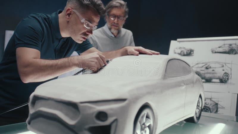 Automotive Design Engineers Discuss Design of Car Looking at the Pencil ...