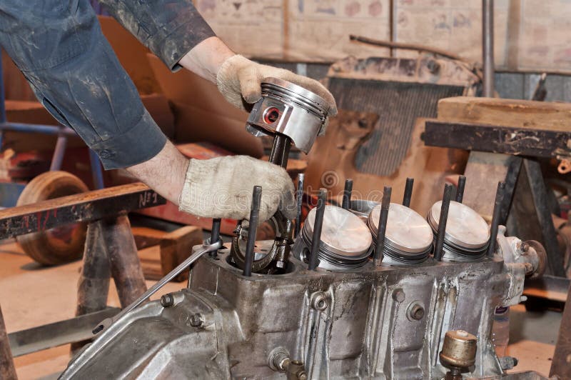 Mechanic Disassembling the Engine, Overhaul.. Engine on a Repair Stand ...