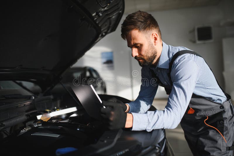 Automotive Mechanic Running Diagnostics Software on Computer. Mechanic ...