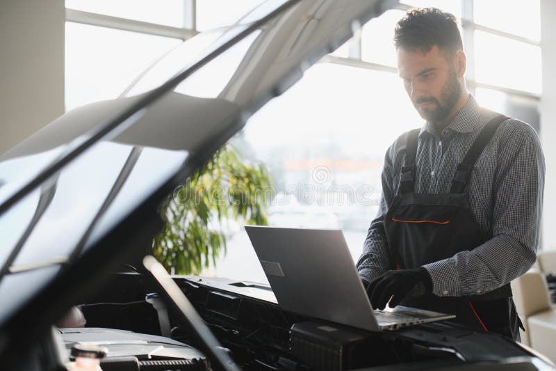 Automotive Mechanic Running Diagnostics Software on Computer. Mechanic ...