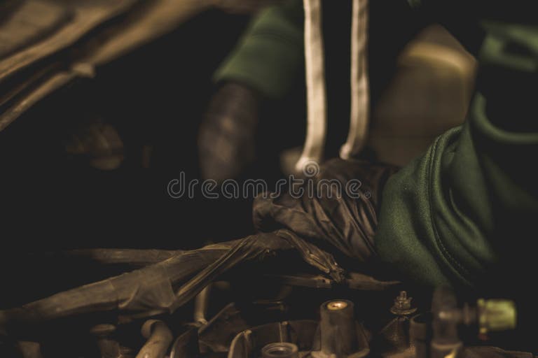 Automotive Mechanic Working in Engine Compartment of an SUV. Stock ...