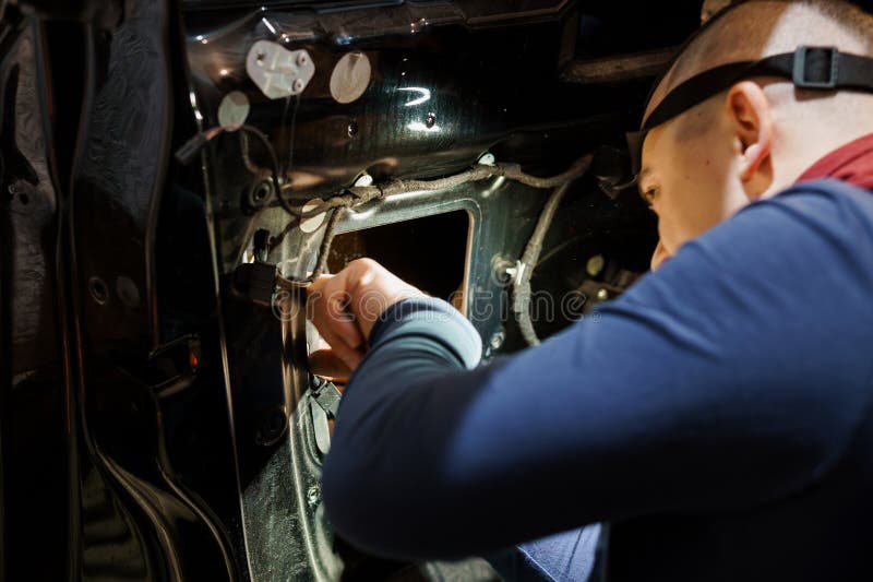 Automotive Technician Working on Car Interior Components with Precision ...