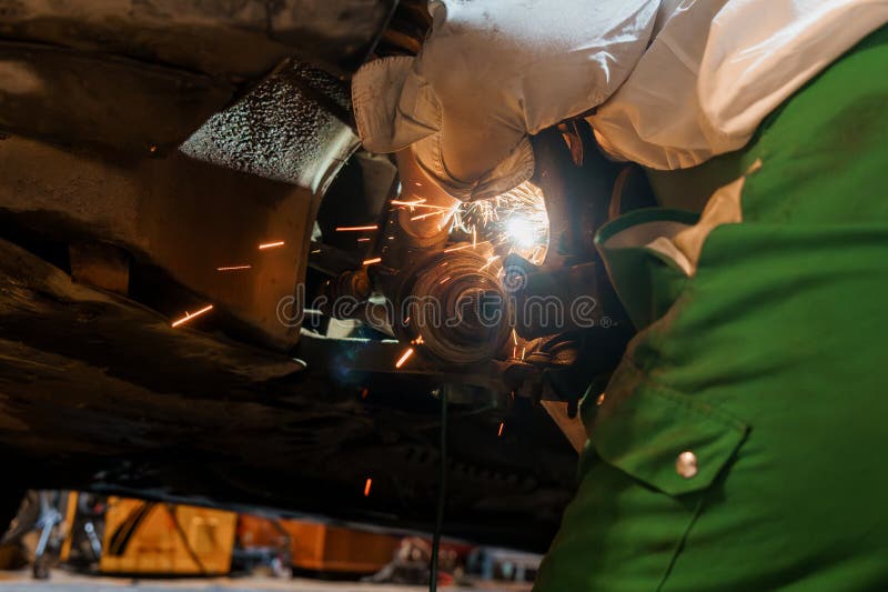 An Automotive Technician Working on a Car S Mechanical Components with ...