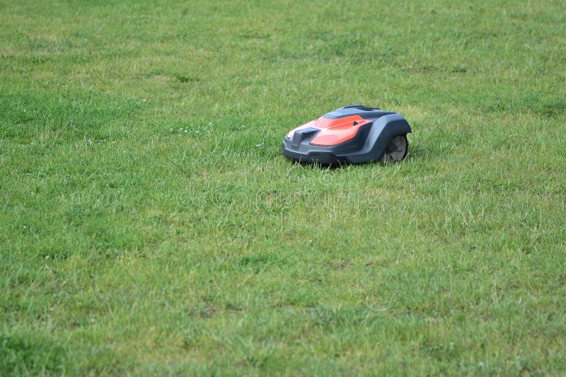 Autonomous Robotic Lawn Mower Working on a Grass. Stock Photo - Image ...