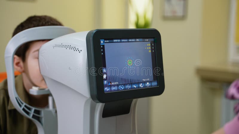Autorefractor Performing Eye Examination on Young Patient Stock Footage ...