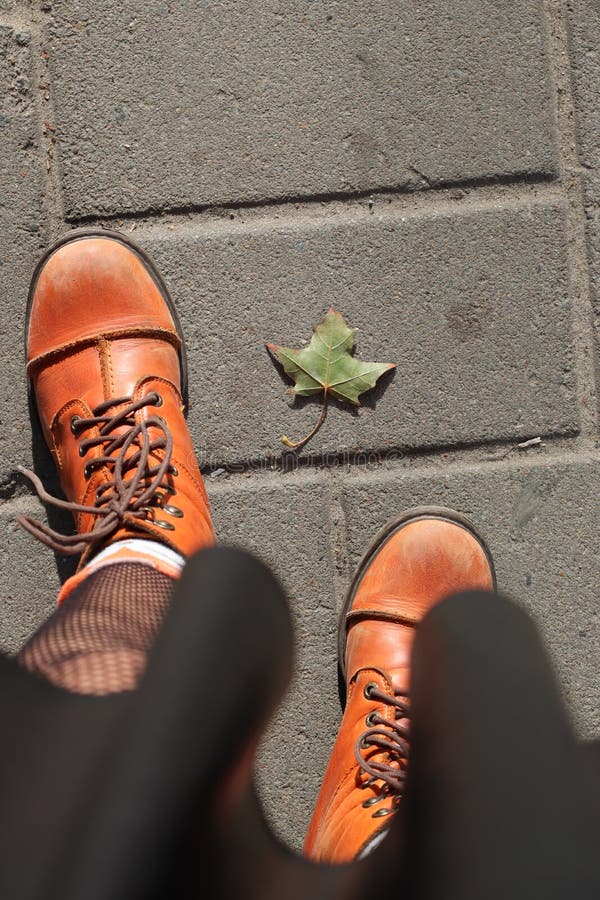 Autumn boots leaf stock image. Image of black, hand - 217547007