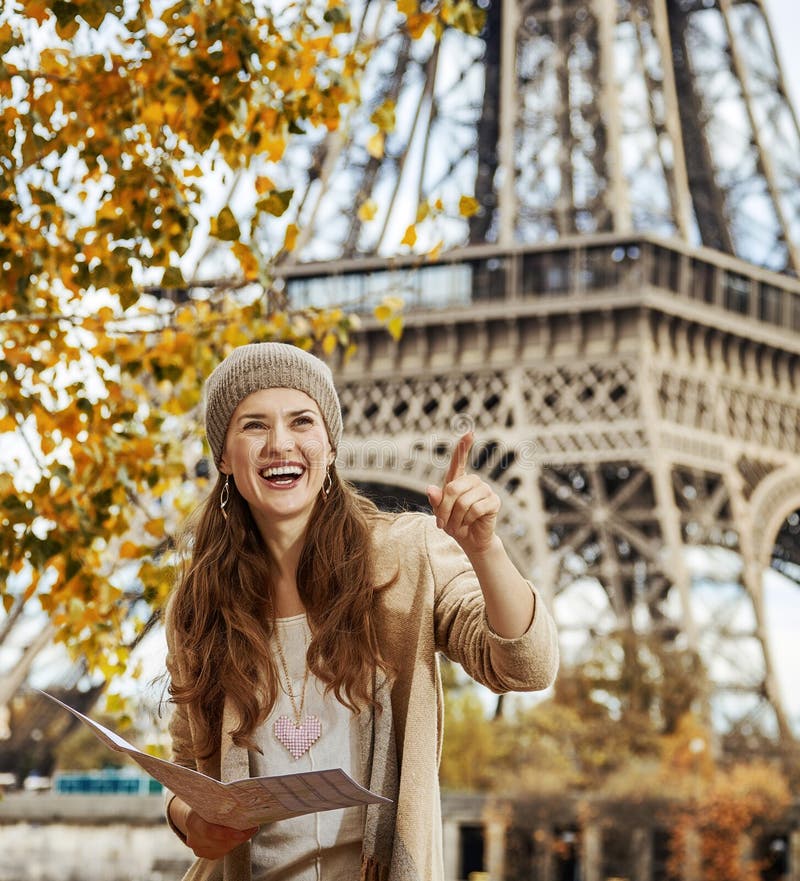 Elegant Woman on Embankment in Paris Holding Map and Pointing Stock ... Elegant Woman on Embankment in Paris Holding Map and Pointing Stock ...