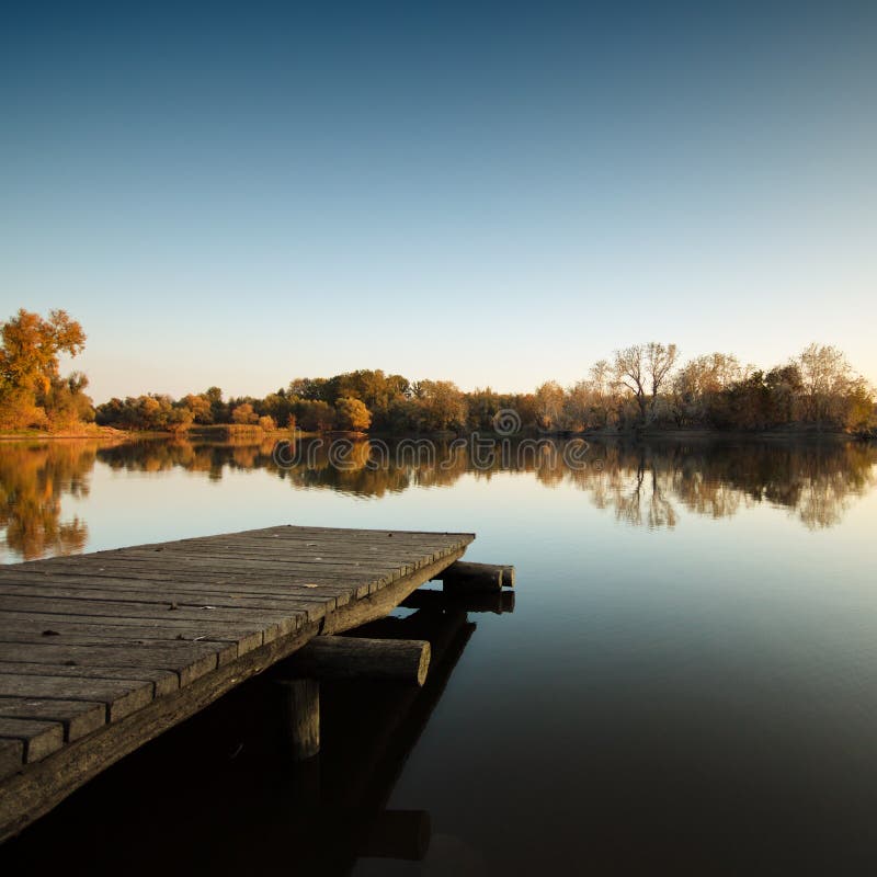 Autumn Lake Scene with Wooden Dock Stock Image - Image of chair ...