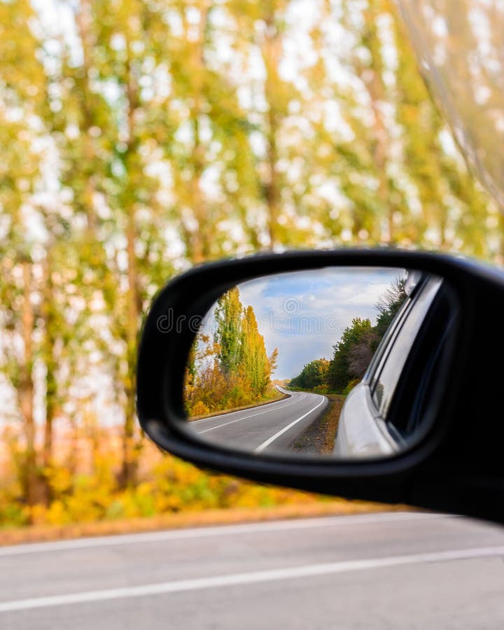 Autumn Landscape is Reflected in the Car Mirror . Cities that Go into ...