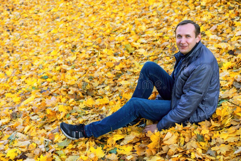 Autumn. Man in the Park on a Background of Yellow Foliage Stock Image ...