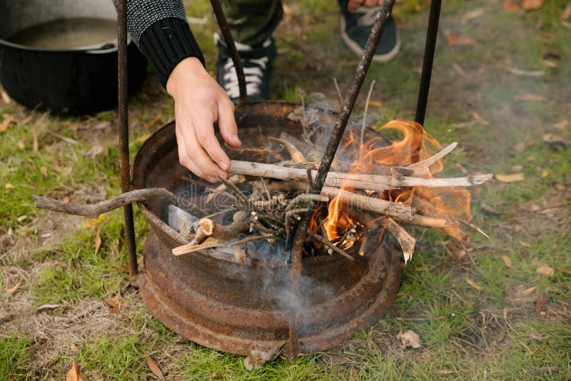 Autumn Vacation Concept. Man Hiker Make Fire in Forest Stock Image ...