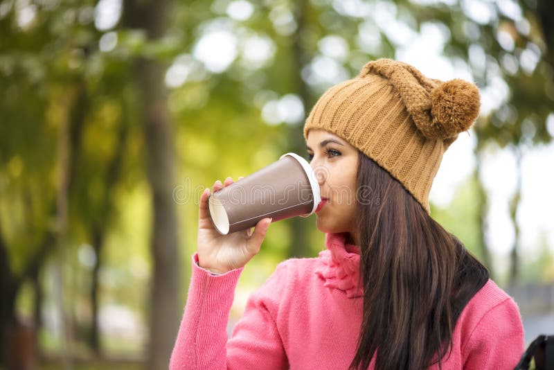 Autumn Woman Drinking Coffee on Park Bench Under Fall Foliage. Stock ...