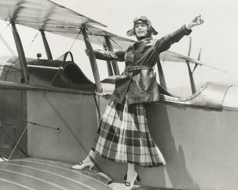 Aviatrix Standing on Bi-plane Stock Photo - Image of away, aviatrix ...