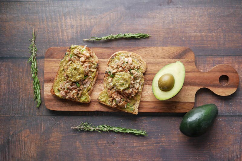 Avocado, Brown Bread, Tuna Fish on Chopping Board on Table Stock Photo ...