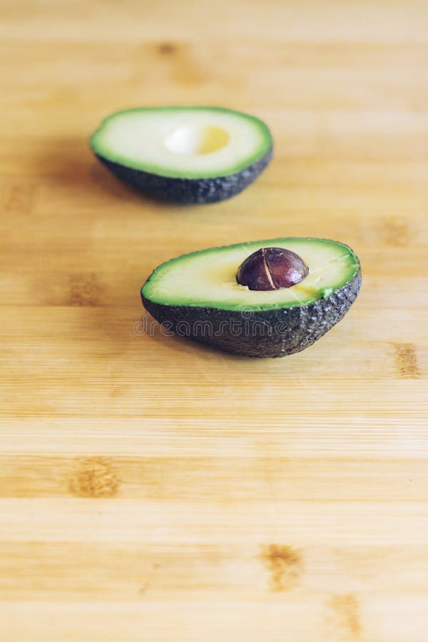 An avocado cut in half stock photo. Image of fruit, changing - 156777686