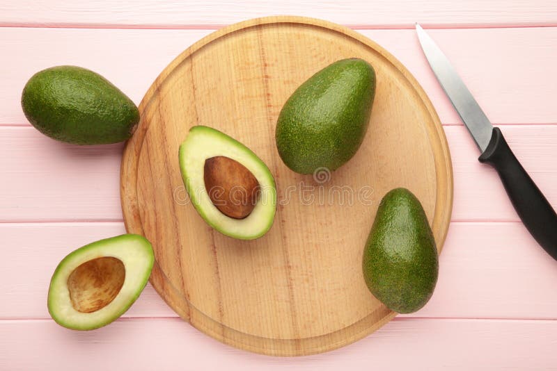 Avocado on a Cutting Board on Pink Table Stock Photo - Image of meal ...