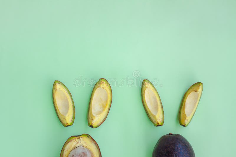 Avocado Fruit and Slice on Green Background, Shaped of Rabbits Ears ...
