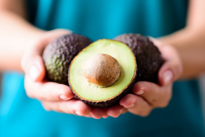 Avocado Fruit in Woman Hand Stock Photo - Image of hand, natural: 161930490