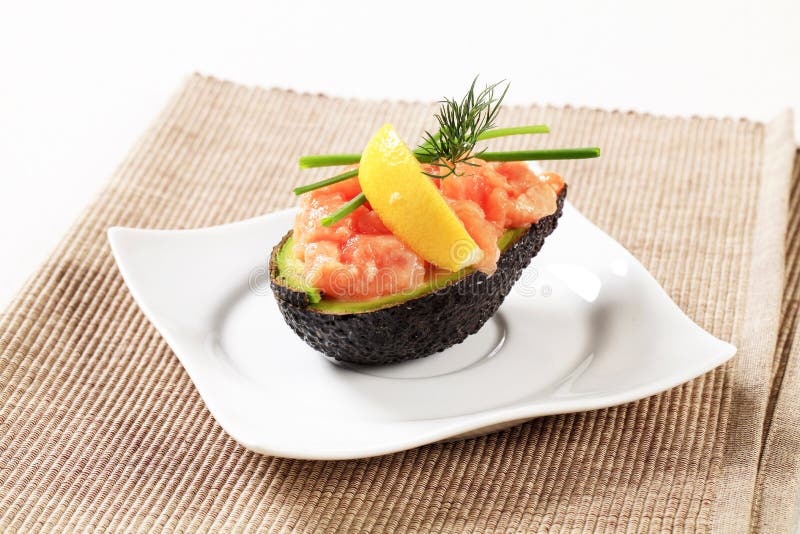 Avocado Half Stuffed with Cured Salmon Stock Photo - Image of lemon ...