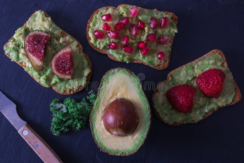 Avocado Open and Prepared on Toasts Stock Image - Image of black ...