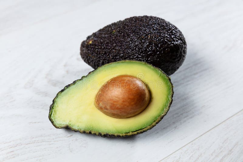 Avocado Open on Wooden Table Stock Image - Image of closeup, sliced ...