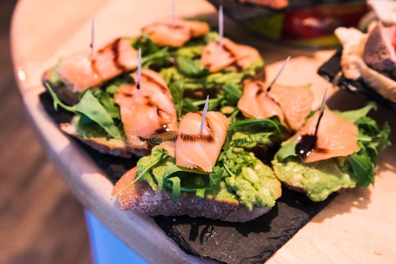 Avocado Pintxos with Salmon and Arugula. Spanish Tapas Called Pintxos ...