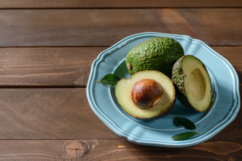 Avocado in plate on table stock image. Image of closeup - 160560507