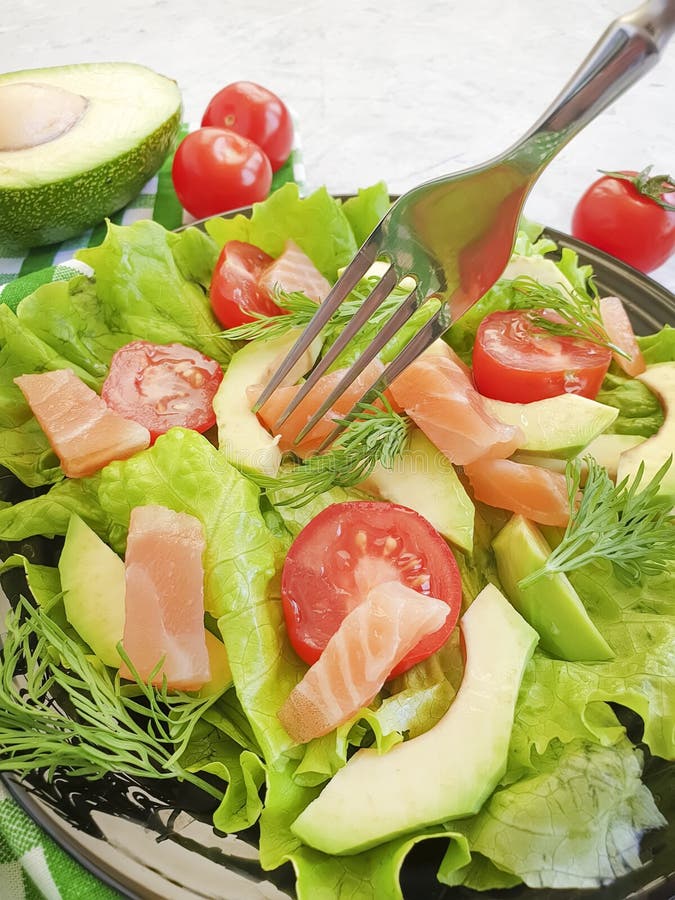 Avocado Salad, Red Fish on Gray Concrete Background Stock Photo - Image ...