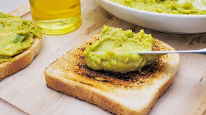 Avocado Spread with Grated Pepper and Toasted Sliced of Bread Stock ...