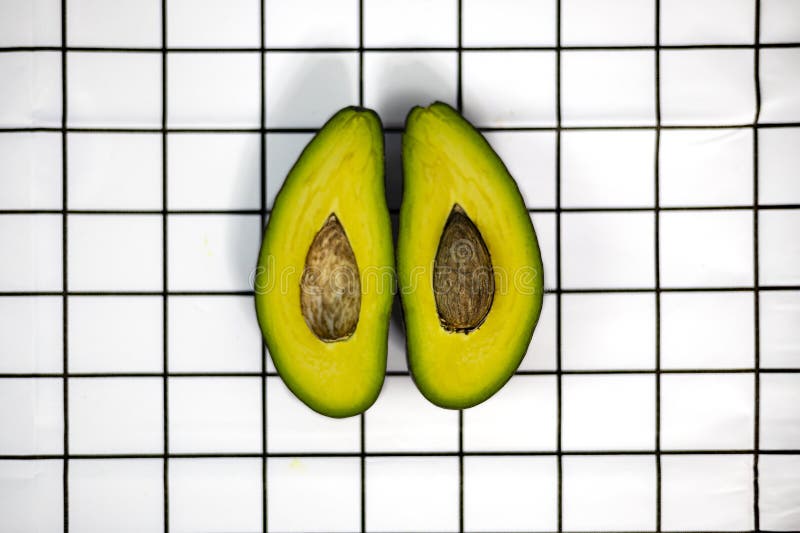 Avocado on a Square Table stock photo. Image of fruit - 361399600
