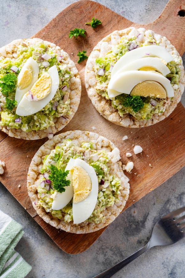 Avocado Tuna Salad on Rice Cakes with Red Onions and Boiled Egg. Stock ...