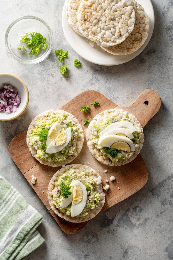 Avocado Tuna Salad on Rice Cakes with Red Onions and Boiled Egg. Stock ...