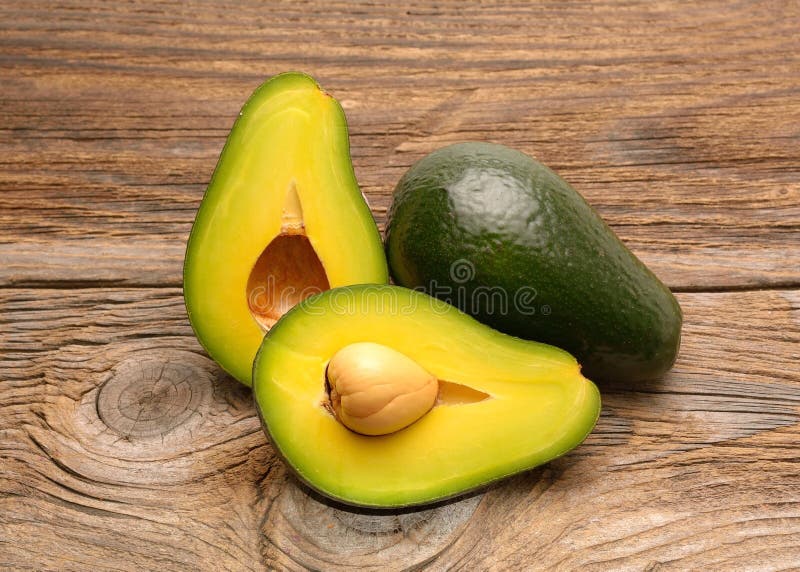 Avocados on a wood table stock image. Image of nature - 100068619
