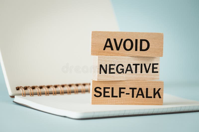 Avoid Negative Self-talk Written on Wooden Blocks Standing on an Open ...
