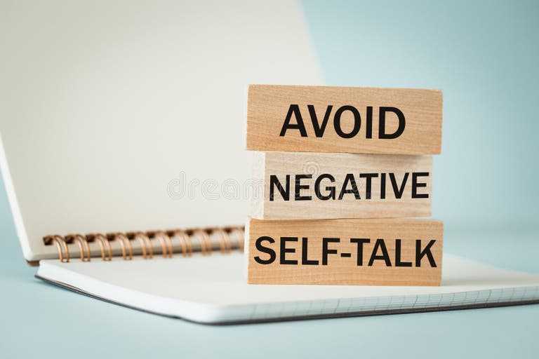 Avoid Negative Self-talk Written on Wooden Blocks Standing on an Open ...